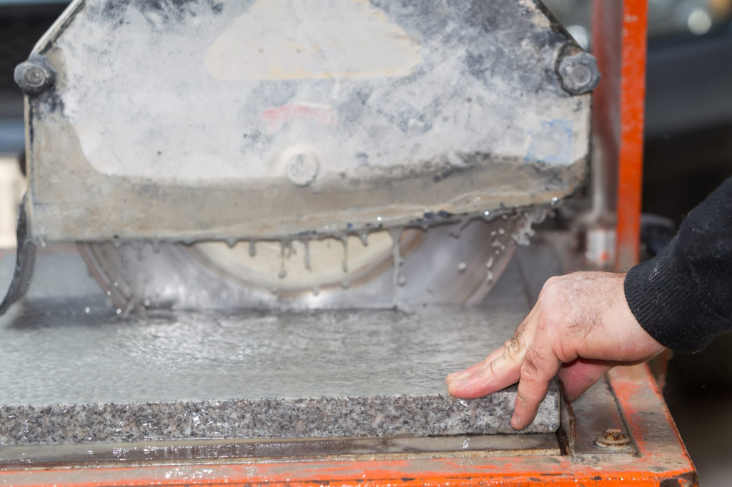 Workers are working, cutting marble cutter Deposit Photos | Elemental Green
